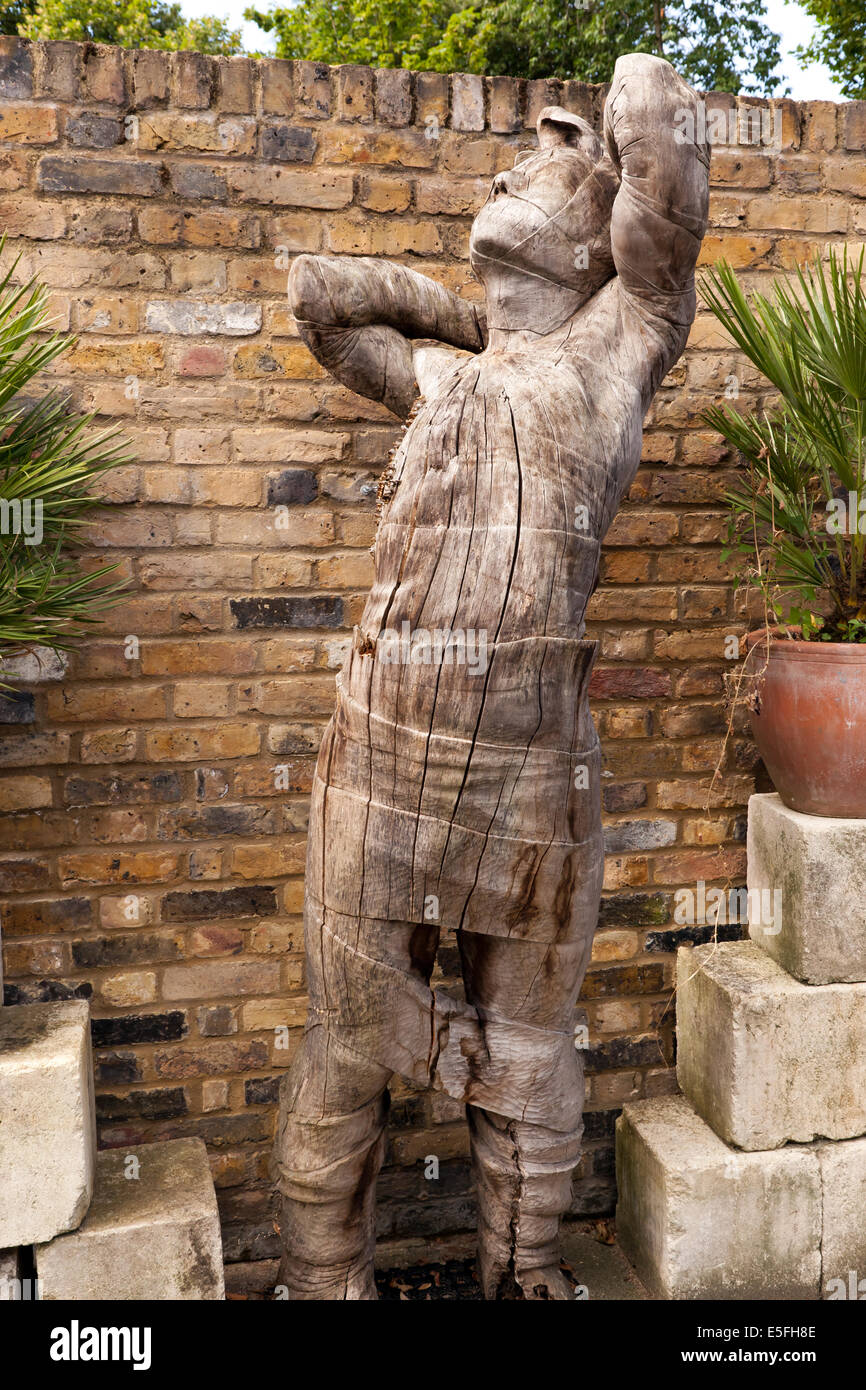 A wooden carved statue in the form of a man, in Wren Mews, at March ...