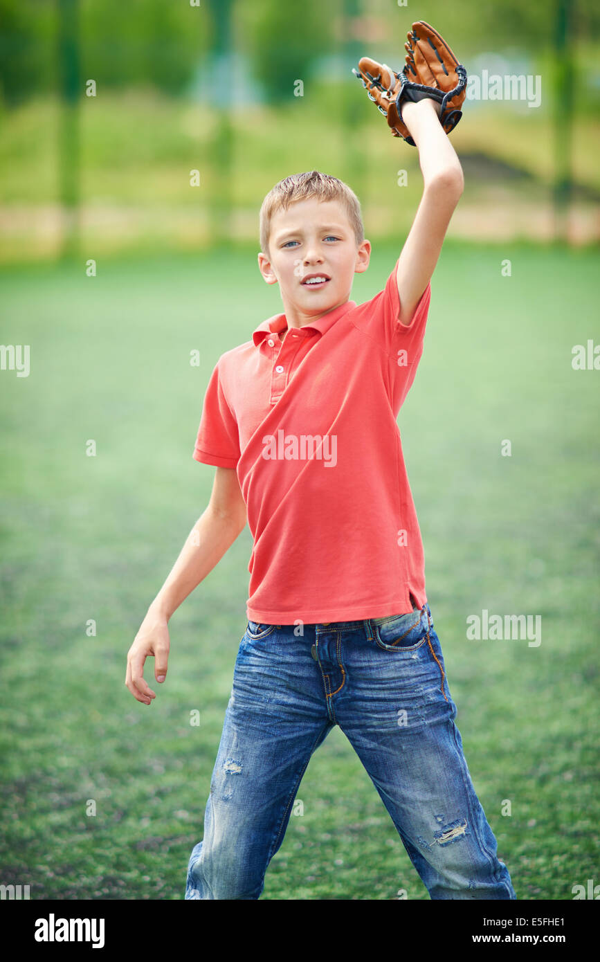 Portrait of active boy catching baseball in the countryside Stock Photo ...