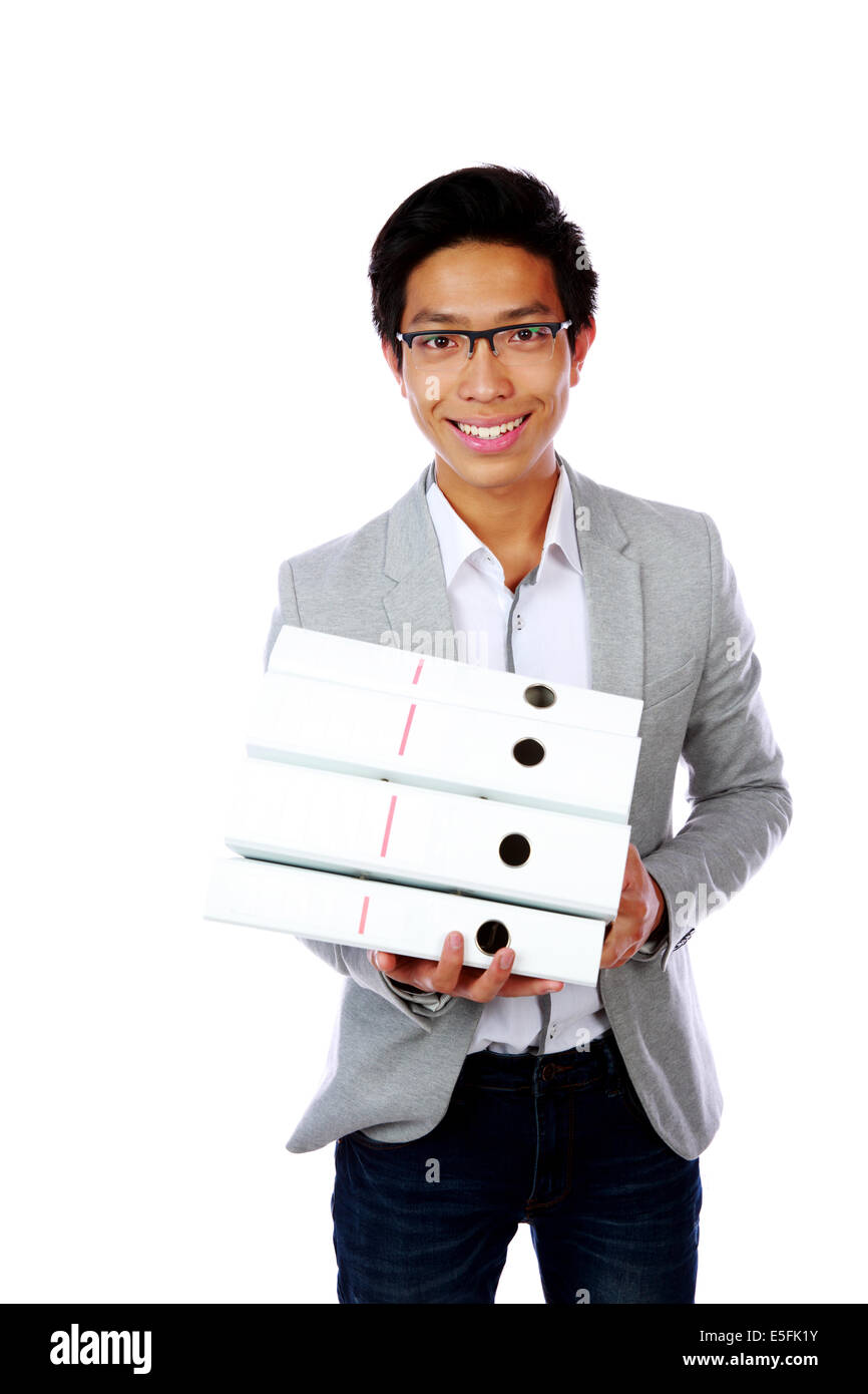 Cheerful asian man with folders standing over white background Stock ...
