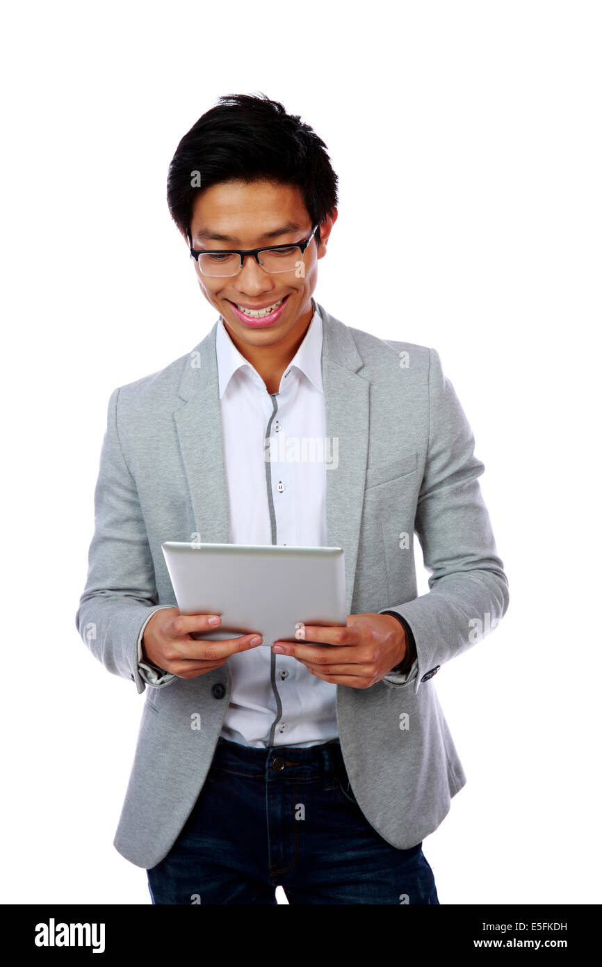 Portrait of a smiling asian man holding tablet computer over white ...