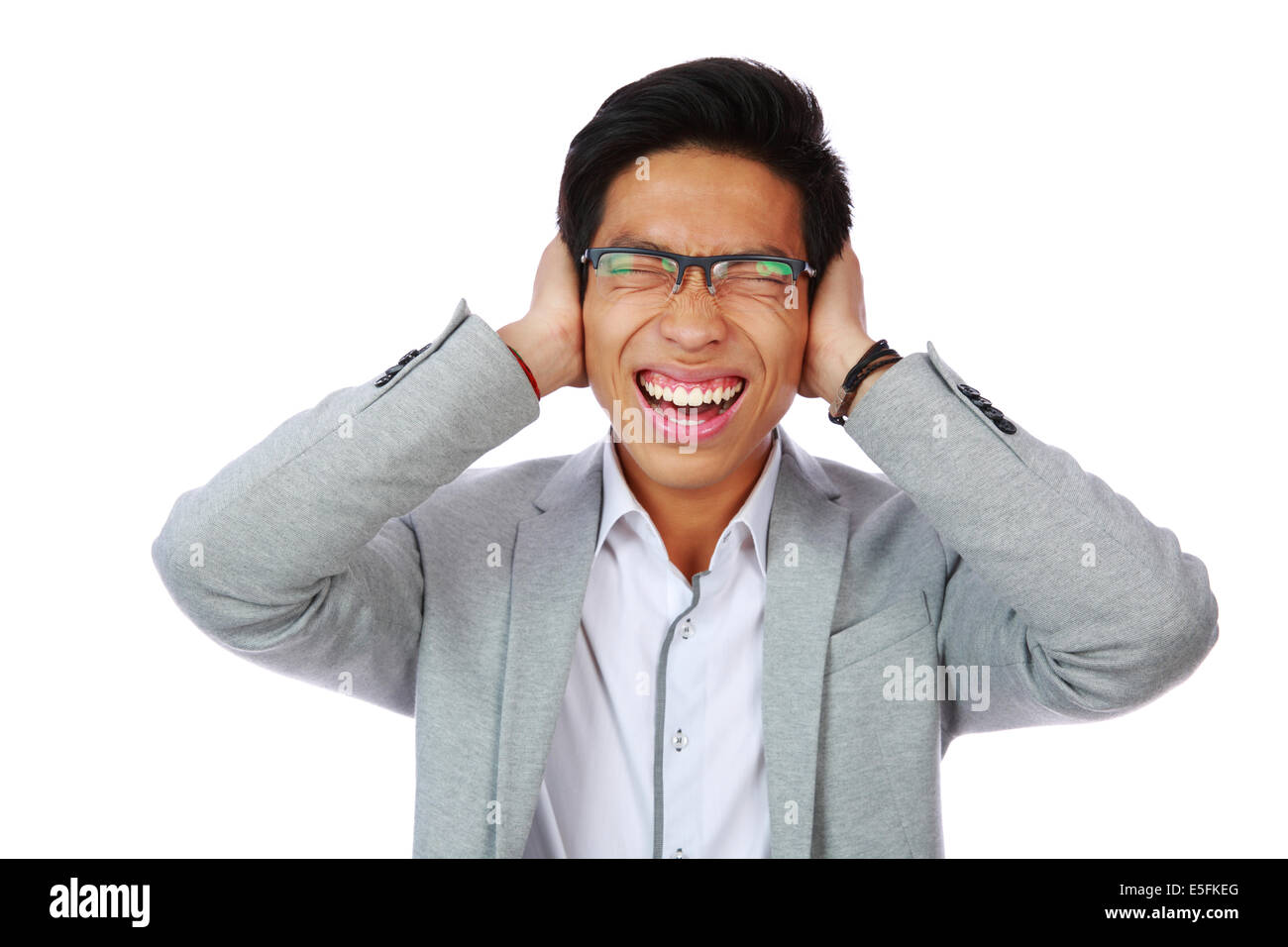Portrait of man holding hands to ears covering to shut out noise Stock ...