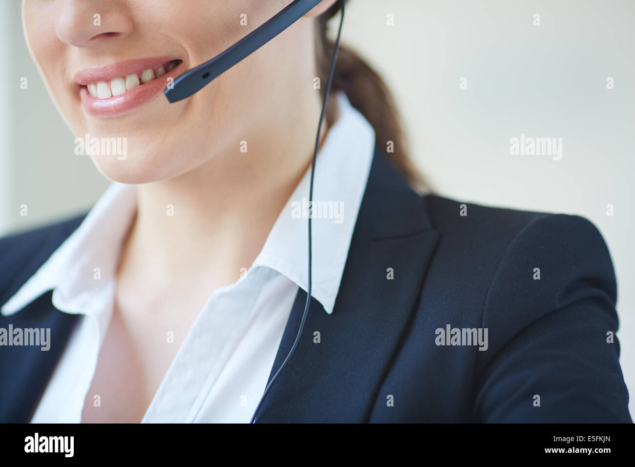 Part of smiley face of young customer support representative Stock ...