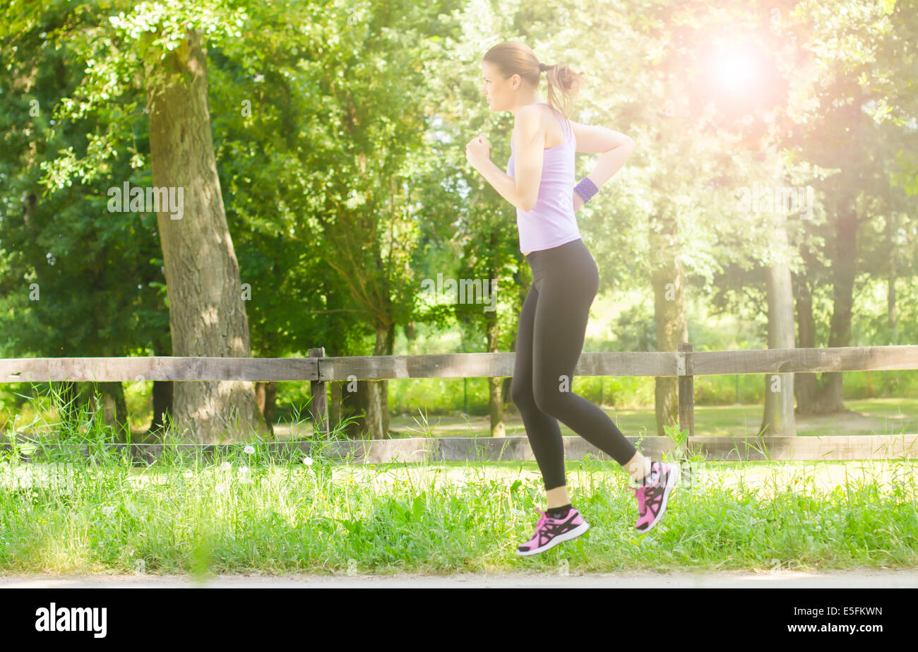 Running woman. Fitness girl jogging in nature Stock Photo - Alamy