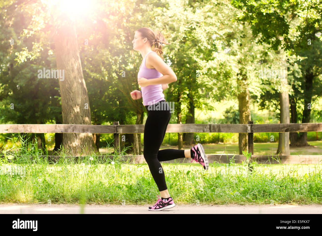 Running woman. Fitness girl jogging in nature Stock Photo - Alamy