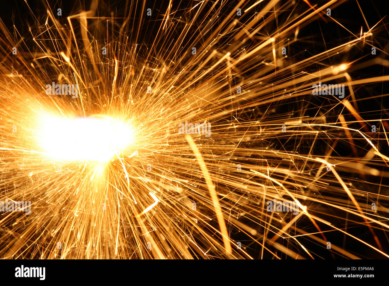 Blazing sparks close-up over black background Stock Photo - Alamy