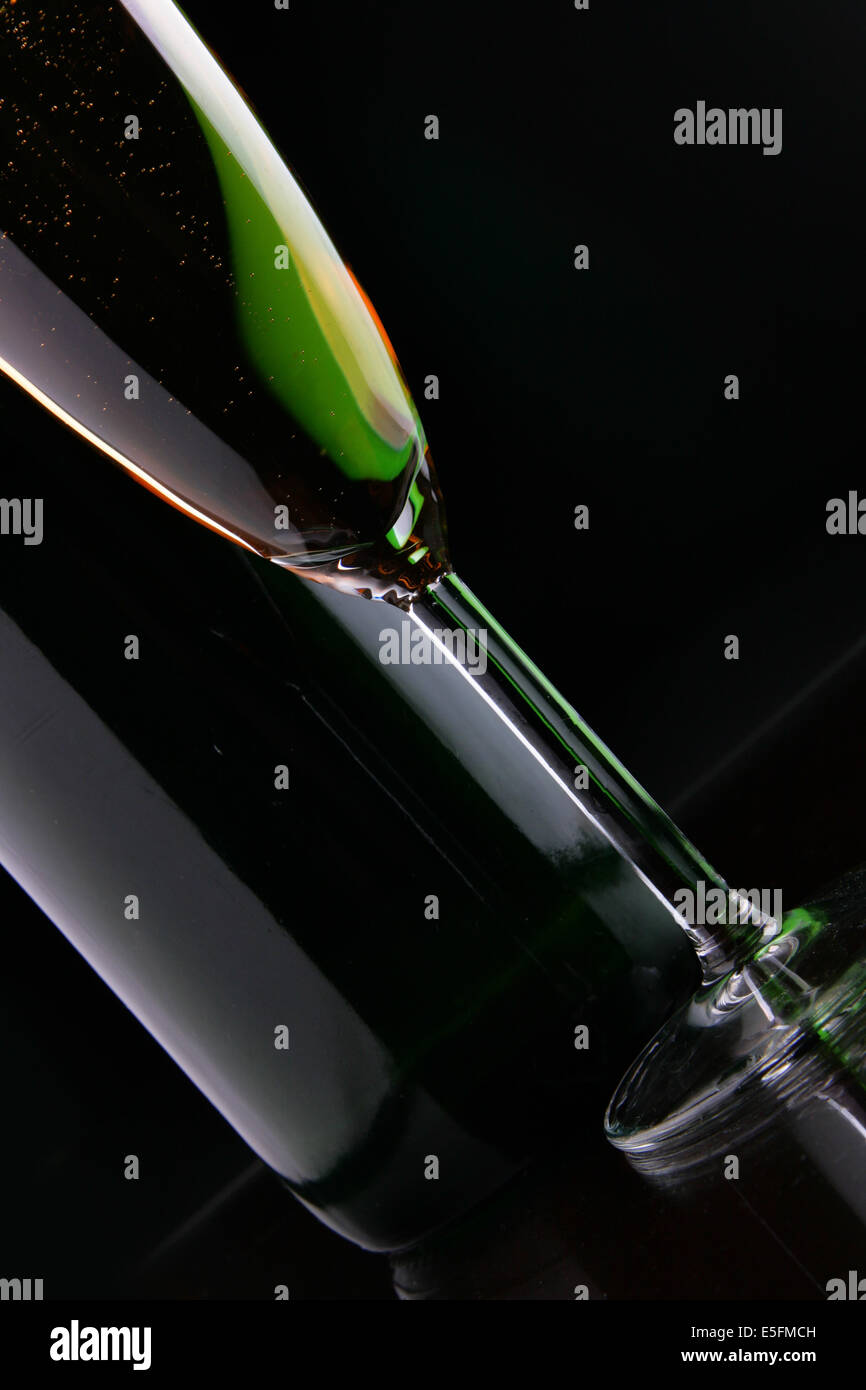 Glass and bottle of champagne close-up over black background Stock ...