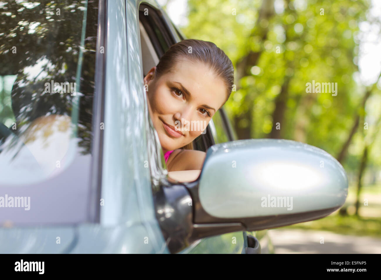 Happy young woman driving a car Stock Photo - Alamy
