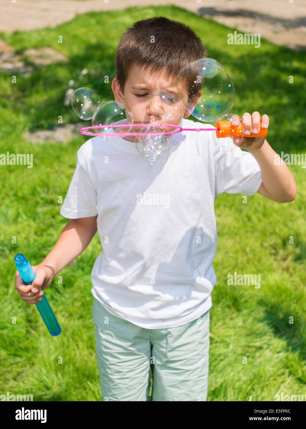 Child makes bubbles. Green park Stock Photo - Alamy