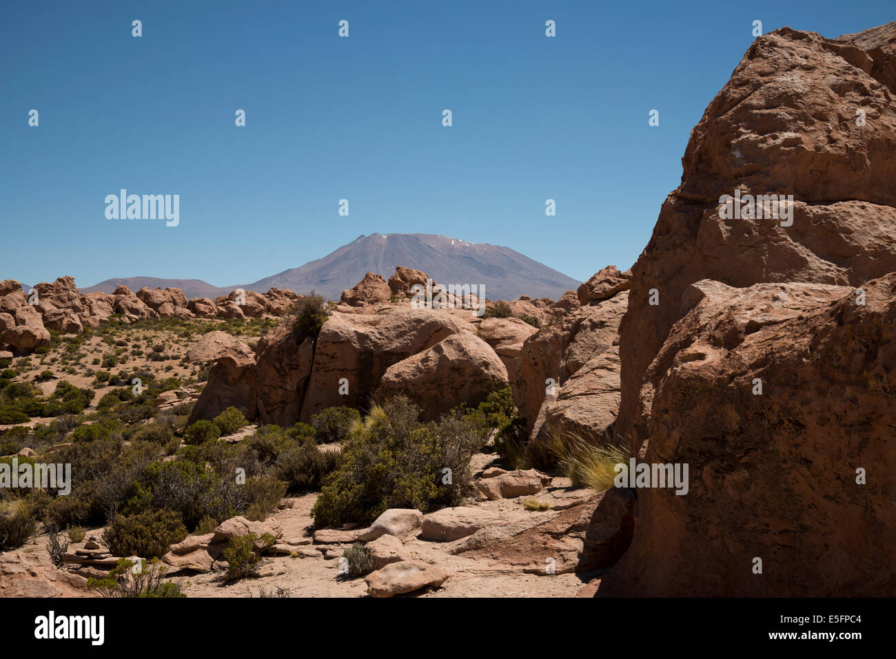 Lava formed rocks with a volcano in the distance in Southern Bolivia ...