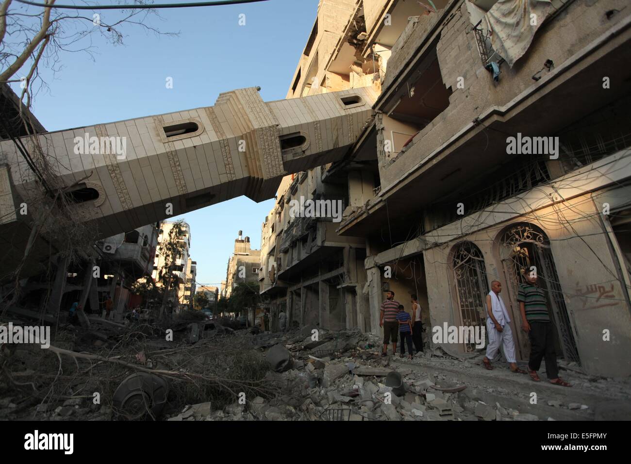 Gaza City, Gaza Strip. 30th July, 2014. Palestinians walk past the ...