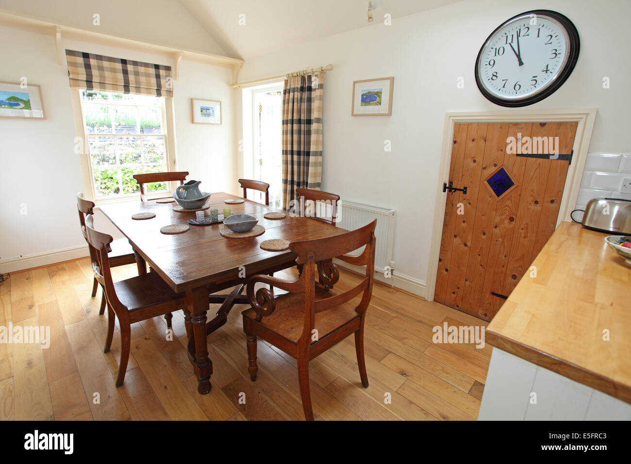 wooden table and chairs in a traditional cottage dining room Stock ...