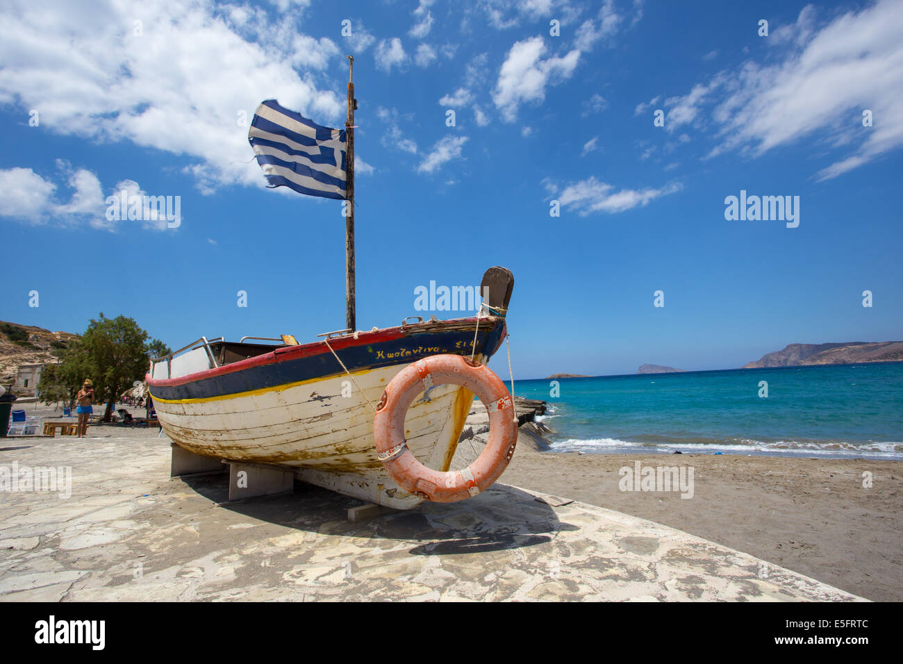 A decorative fishing boat, flying the Greek flag by a restaurant in ...