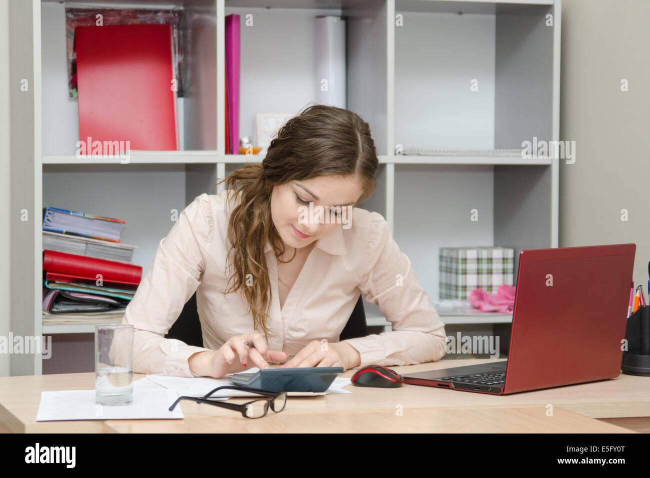 Young girl working at the desk in the office Stock Photo - Alamy