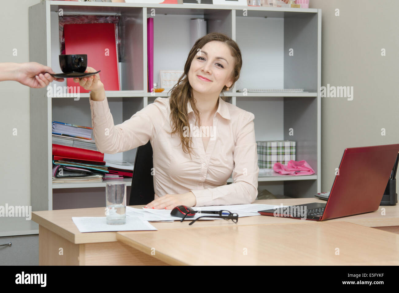 Young girl working at the desk in the office Stock Photo - Alamy