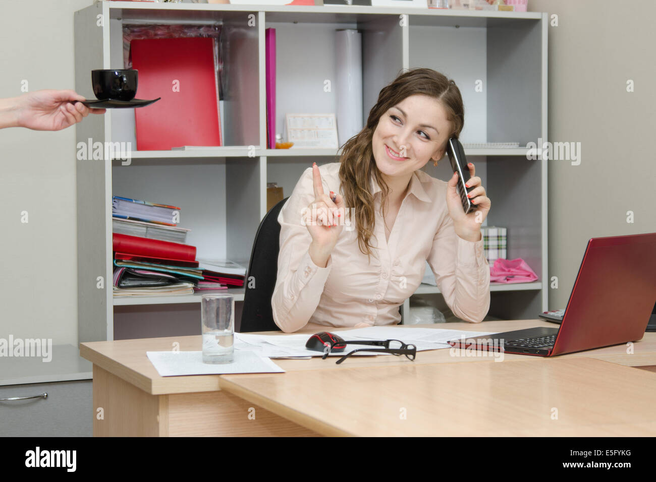 Young girl working at the desk in the office Stock Photo - Alamy