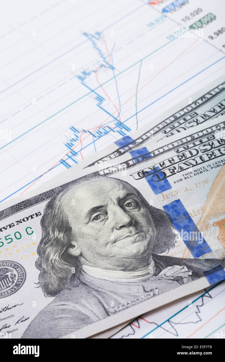 100 dollars banknote over stock market chart - studio shot Stock Photo ...