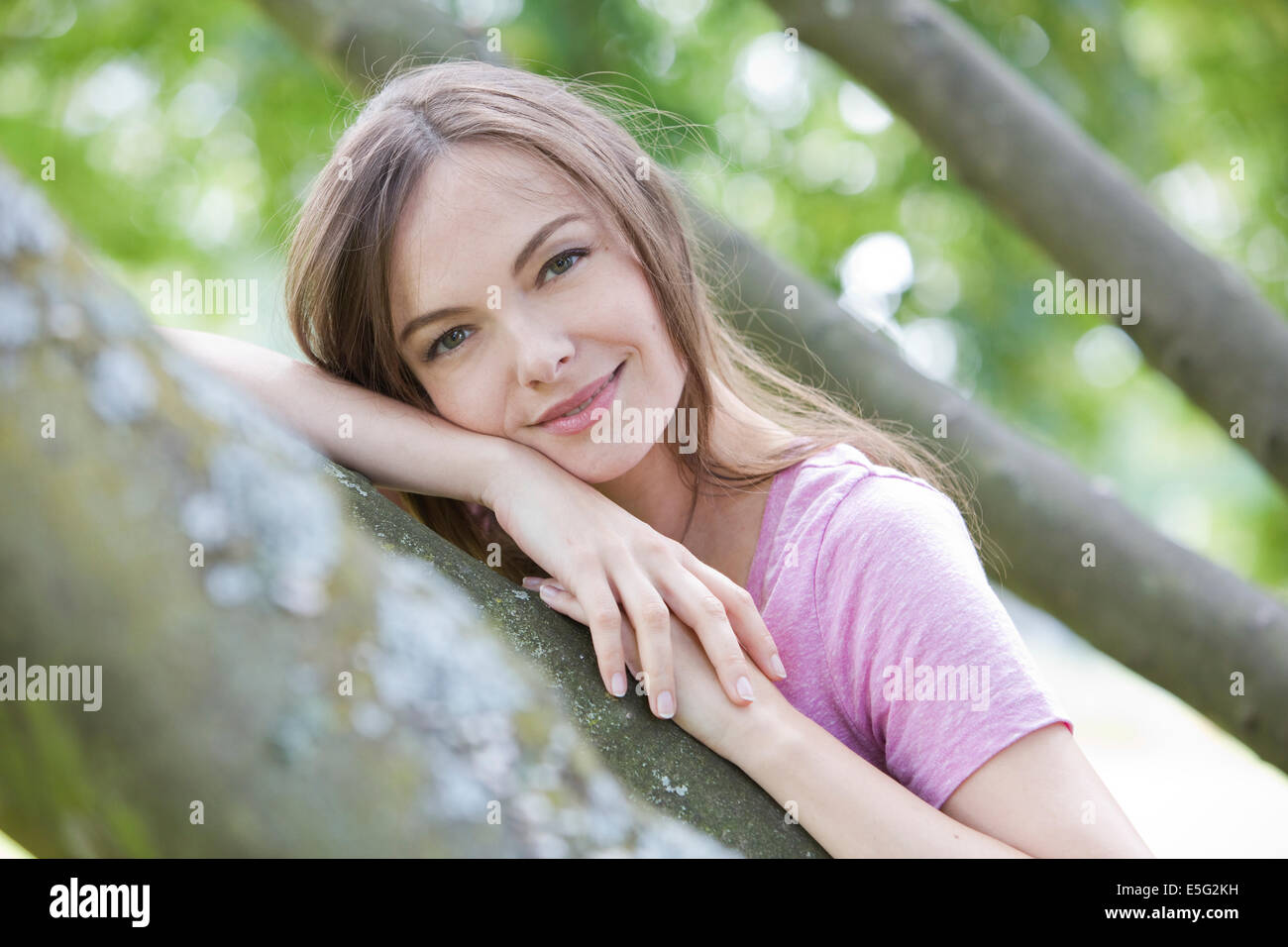 Portrait of a woman at a tree Stock Photo - Alamy