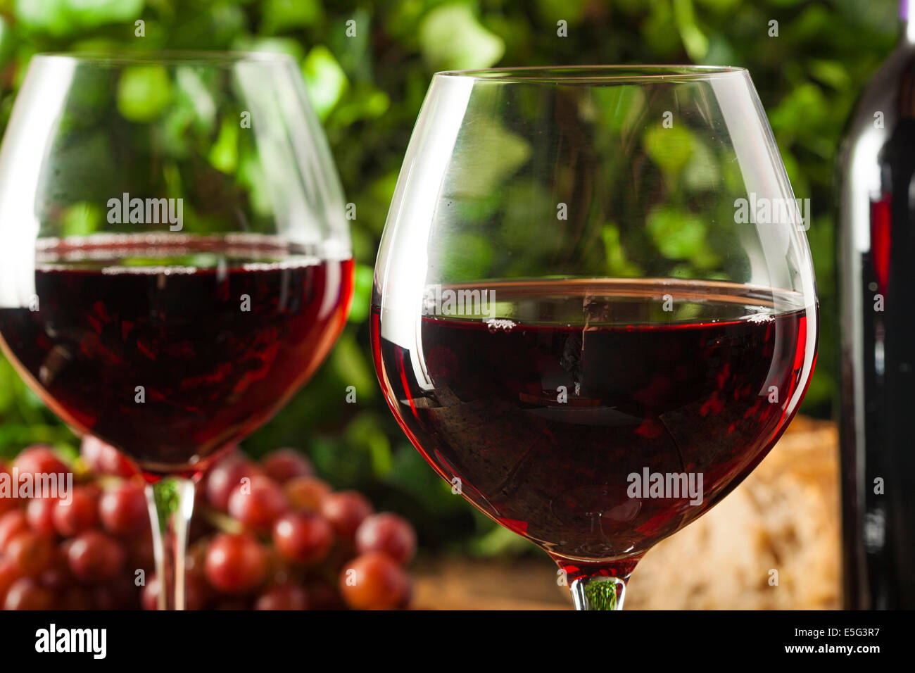 Refreshing Red Wine In a Glass with Grapes Stock Photo - Alamy