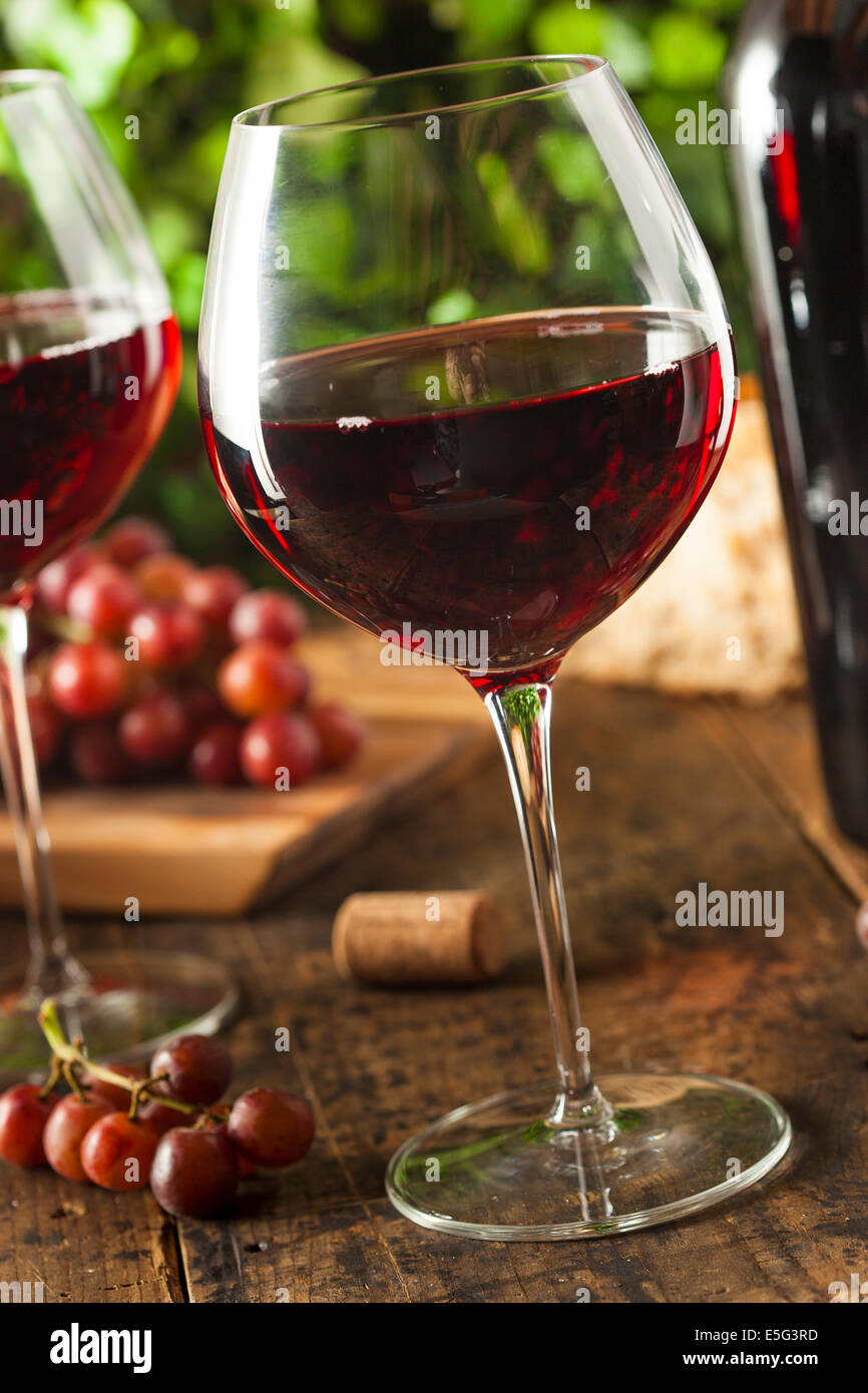 Refreshing Red Wine In a Glass with Grapes Stock Photo - Alamy