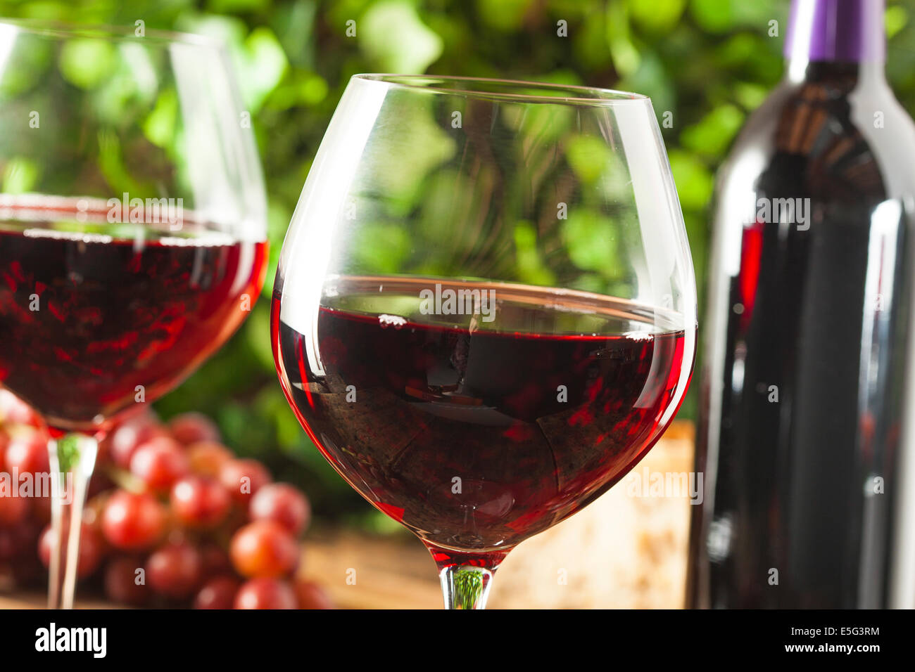 Refreshing Red Wine In a Glass with Grapes Stock Photo - Alamy