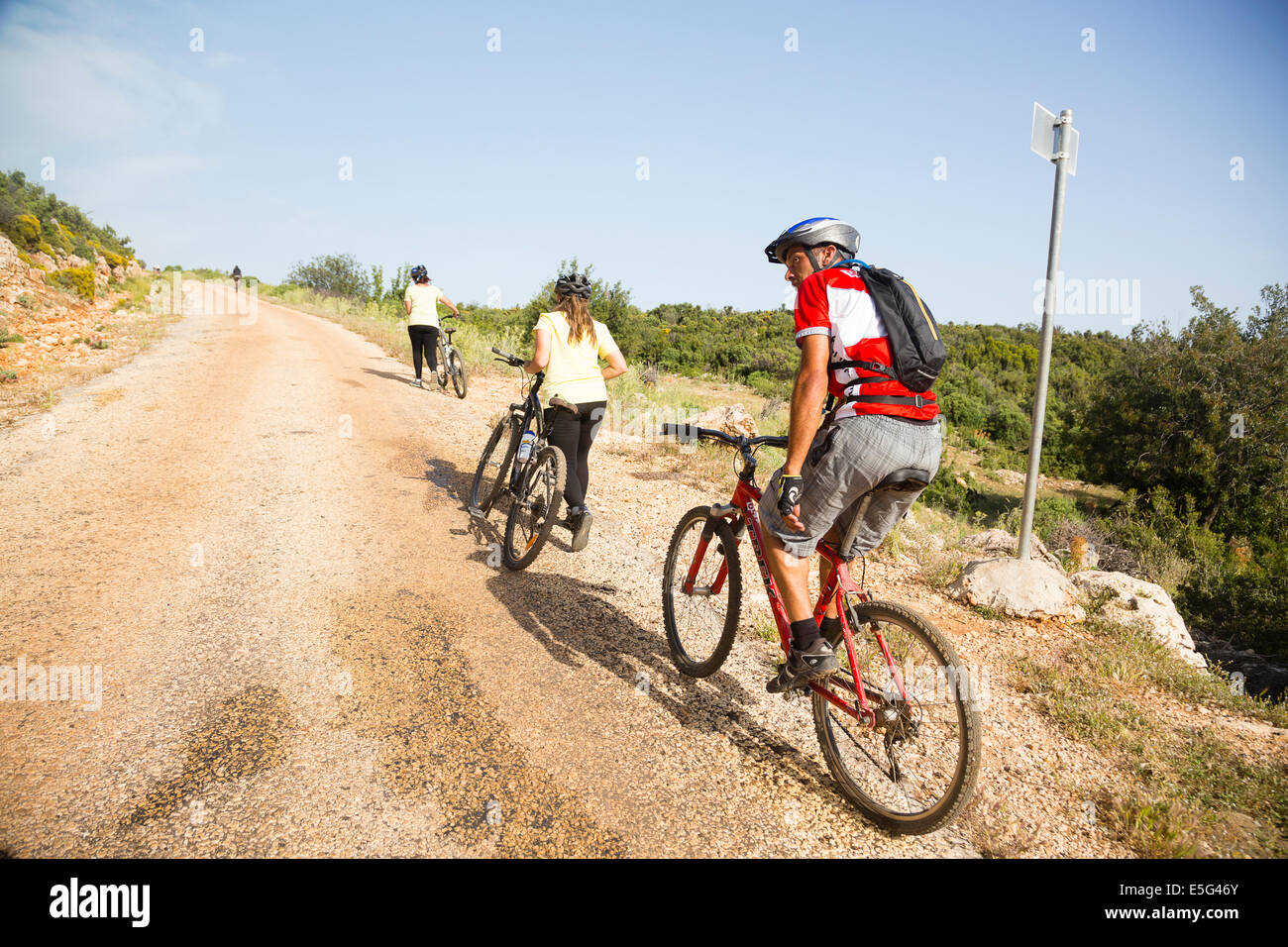 Exodus cycling clients climbing hill Stock Photo - Alamy