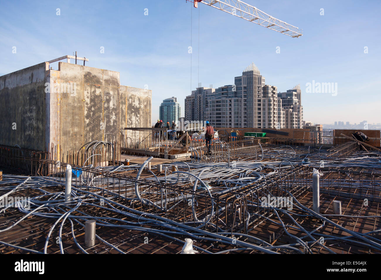 Construction workers on a rooftop construction site in Toronto, Ontario ...
