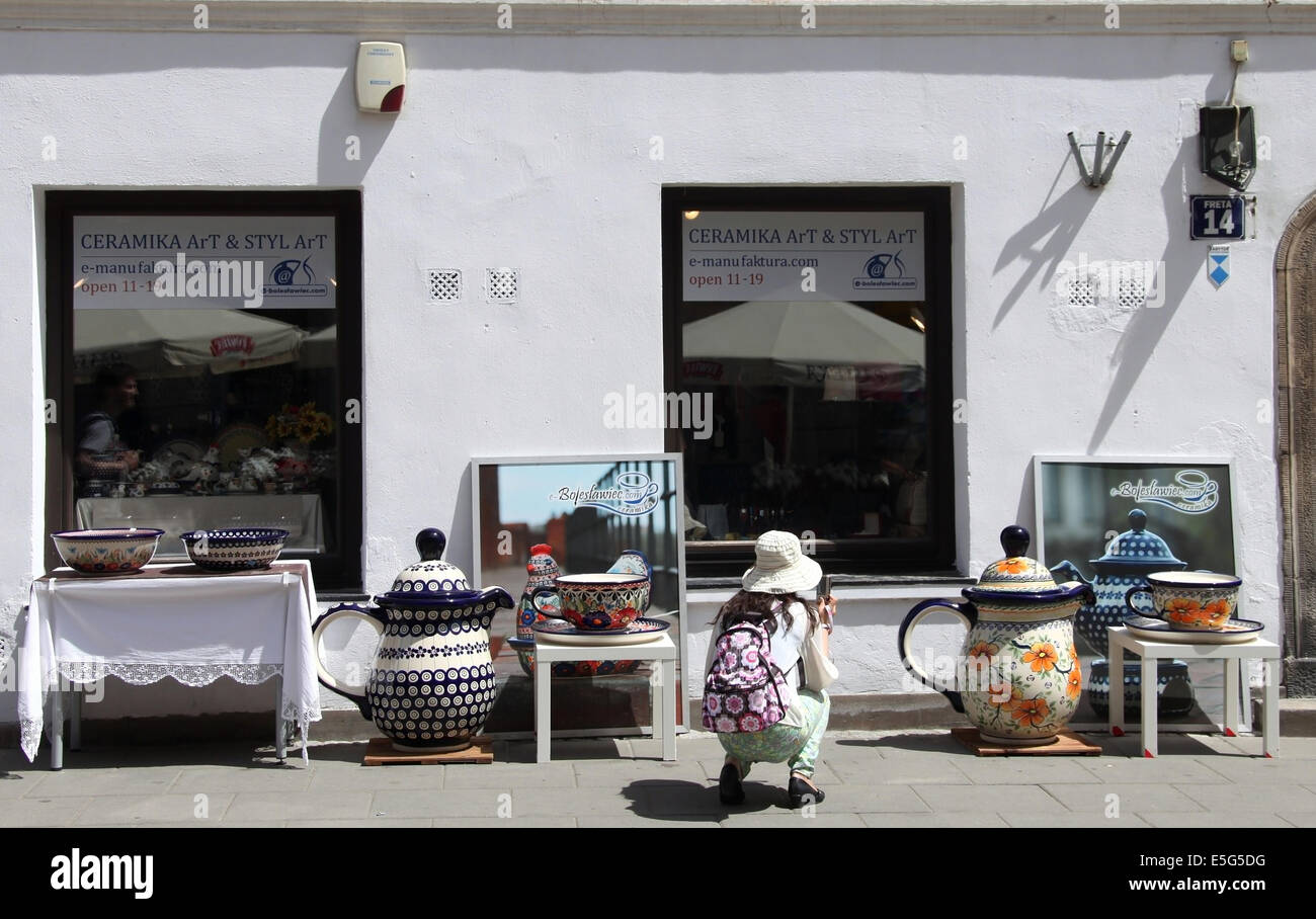 Tourist taking a photograph of a ceramics shop in Warsaw Stock Photo ...
