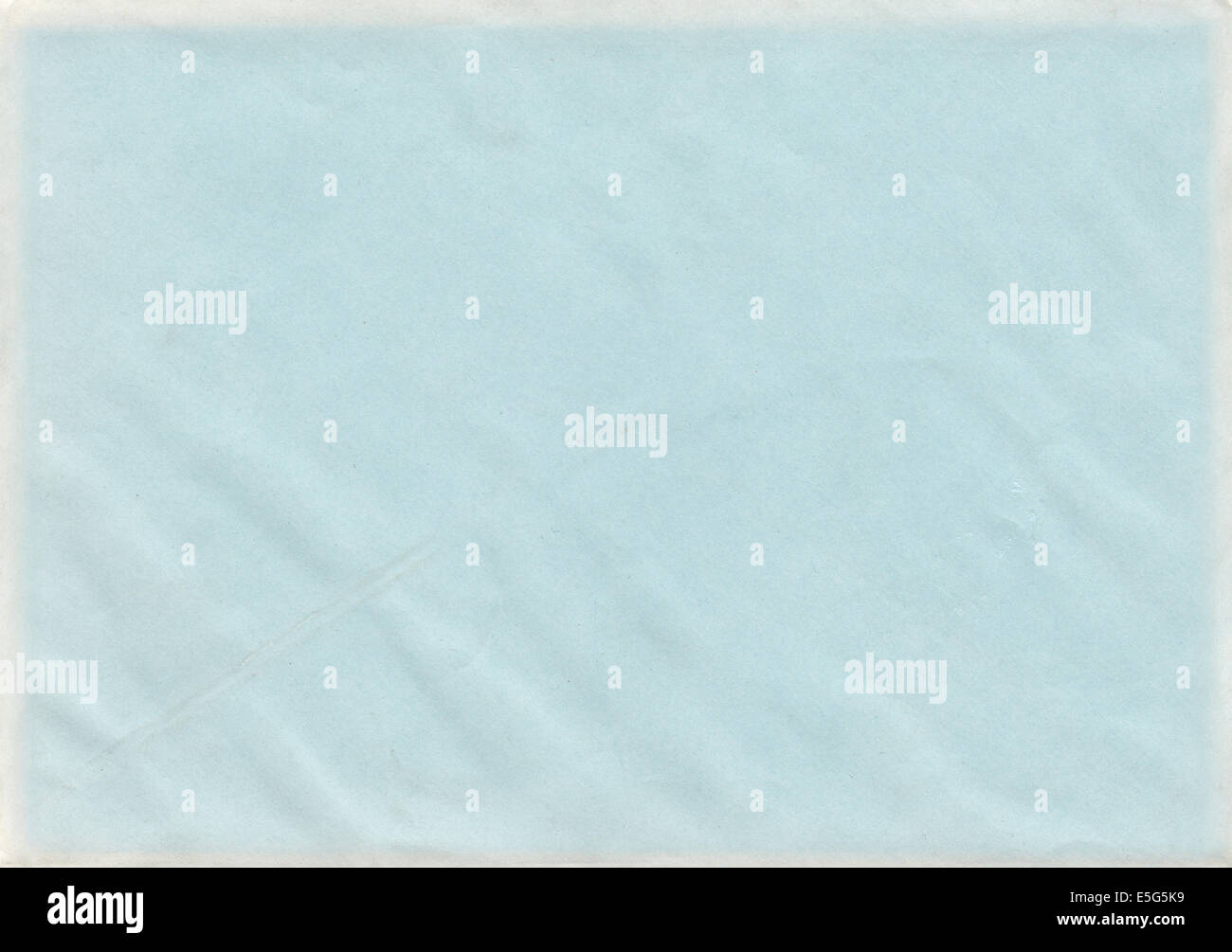 Baby blue color vintage paper with wrinkles and marks and a yellowed ...