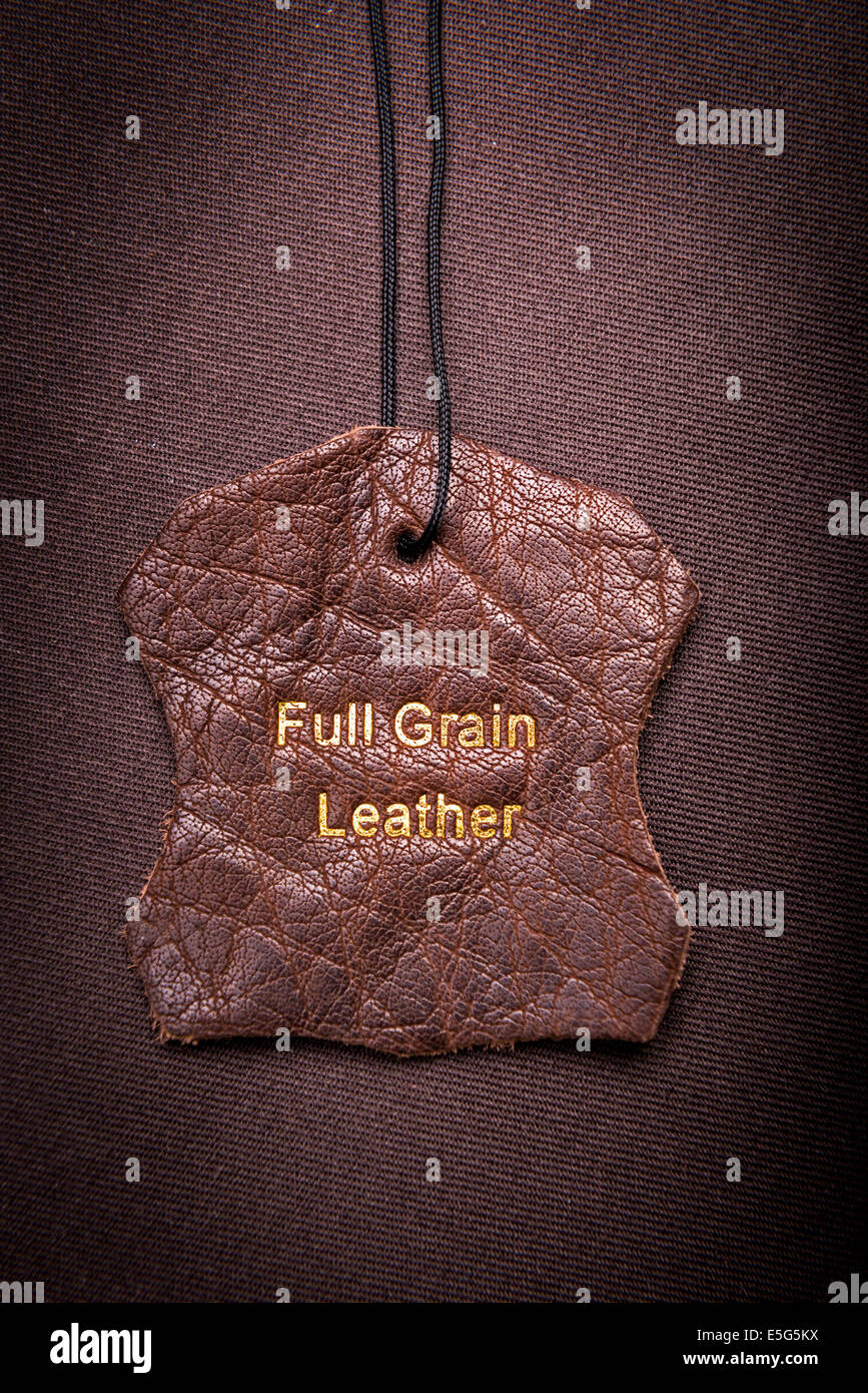 Leather tag with Full Grain Leather text embossed in gold Stock Photo ...