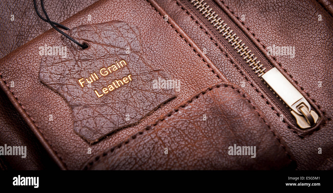 Leather tag with Full Grain Leather text embossed in gold Stock Photo ...