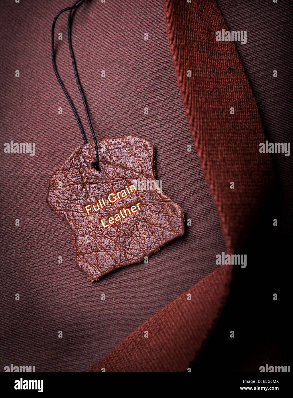 Leather tag with Full Grain Leather text embossed in gold Stock Photo ...