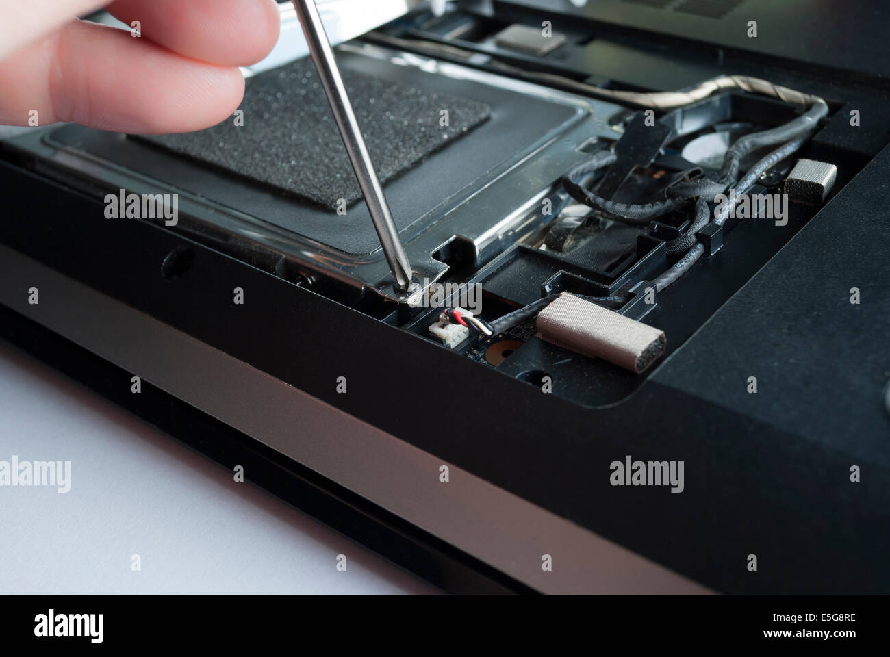 man fixing computer or laptop or notebook with crewdriver Stock Photo ...