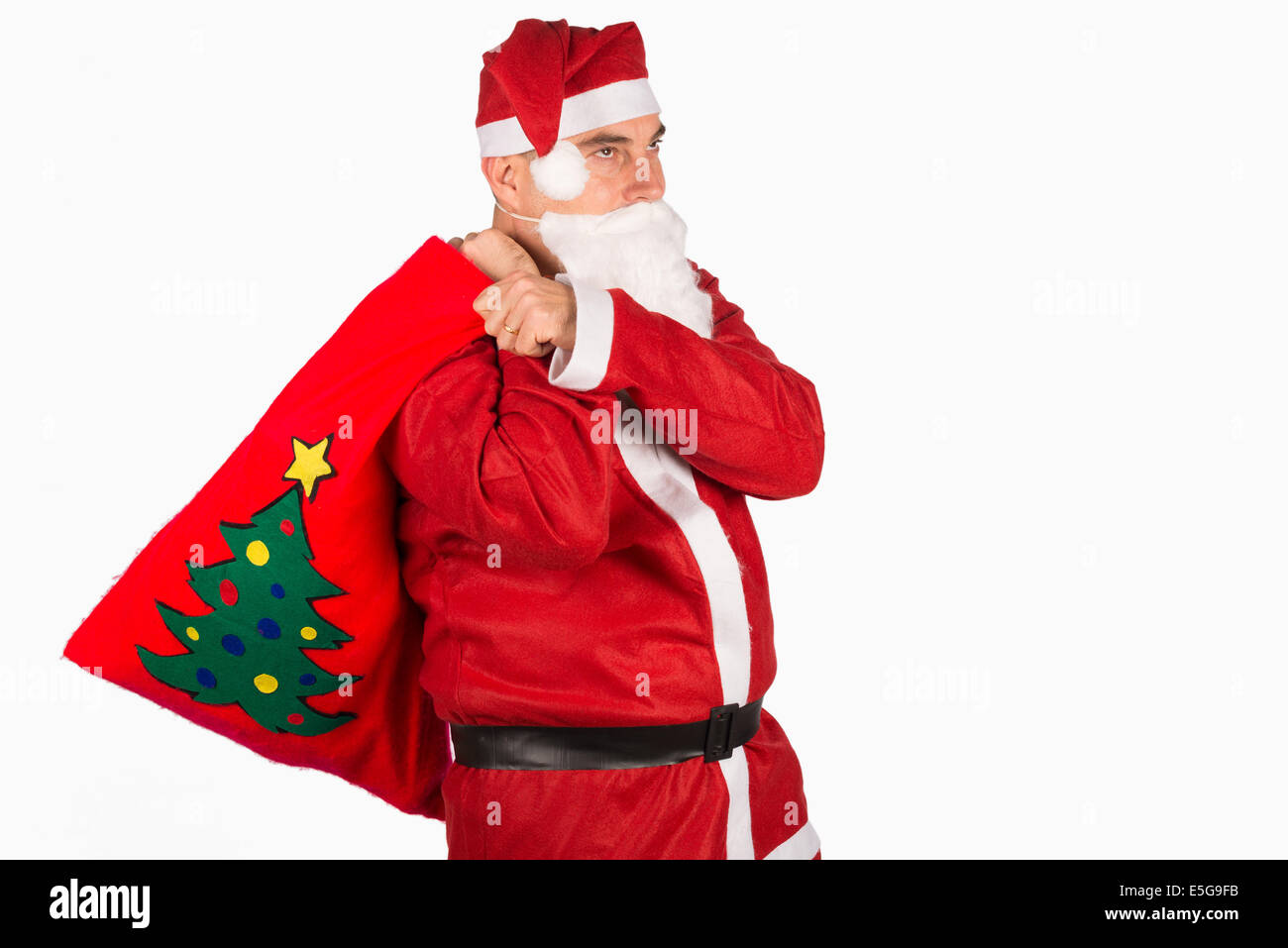 Frustrated looking Santa carrying the gift sack Stock Photo - Alamy