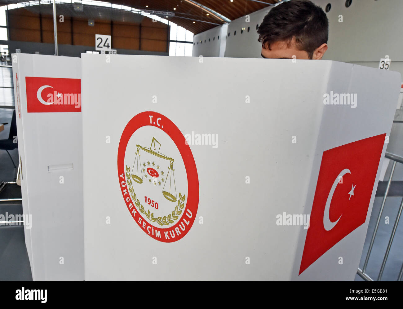 A man stands in a polling booth to demonstrate the process of voting to ...