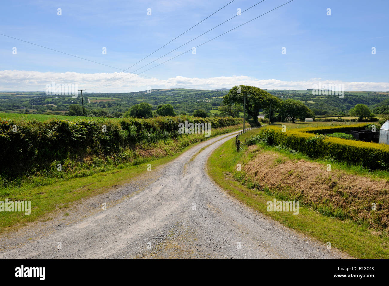 Junction of two dirt track roads with green countryside beyond, UK ...