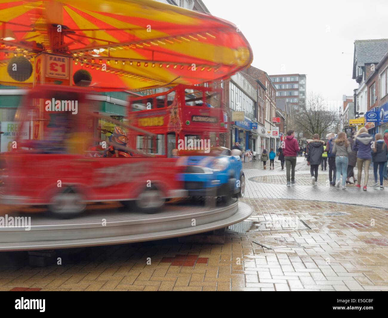 A children's roundabout in the rain Stock Photo - Alamy