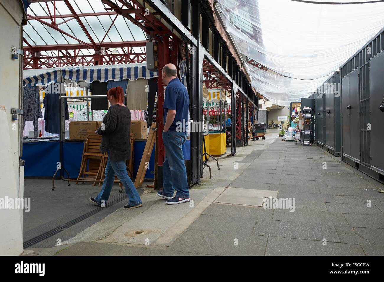 A corridor created by temporary storage containers and the old covered ...