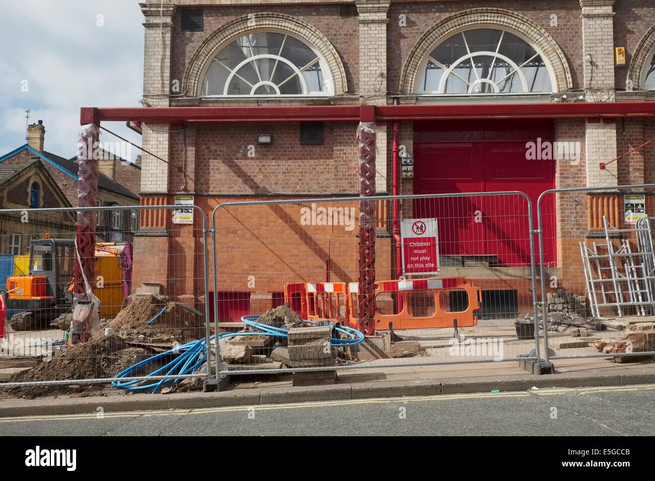 Construction work on a new glass covered area designed to look match ...