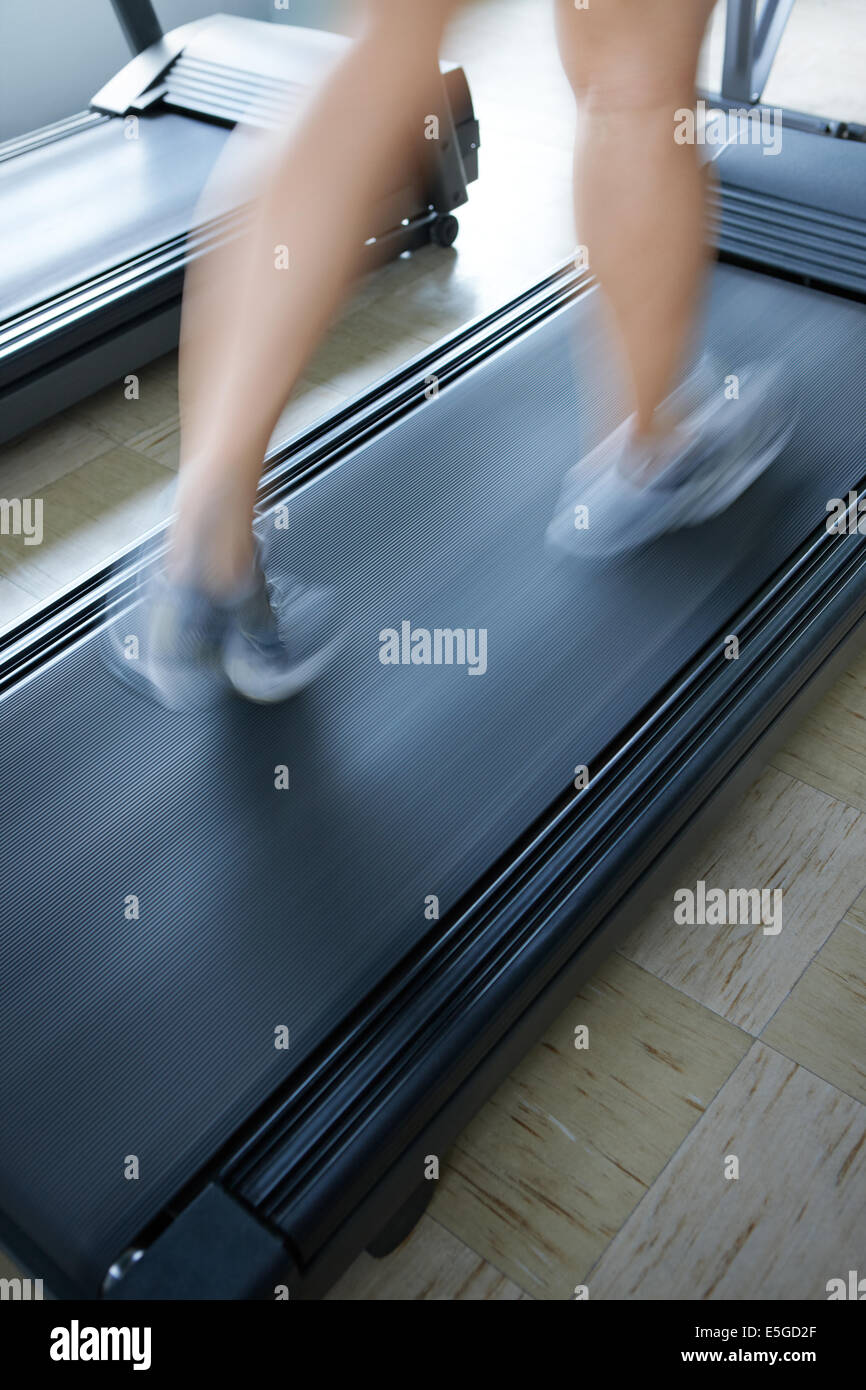 legs running on treadmill with motion in gym Stock Photo - Alamy