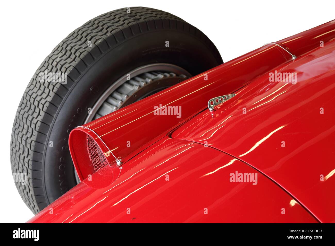 Closeup of the wheel and tire of a red classic racing car. White ...