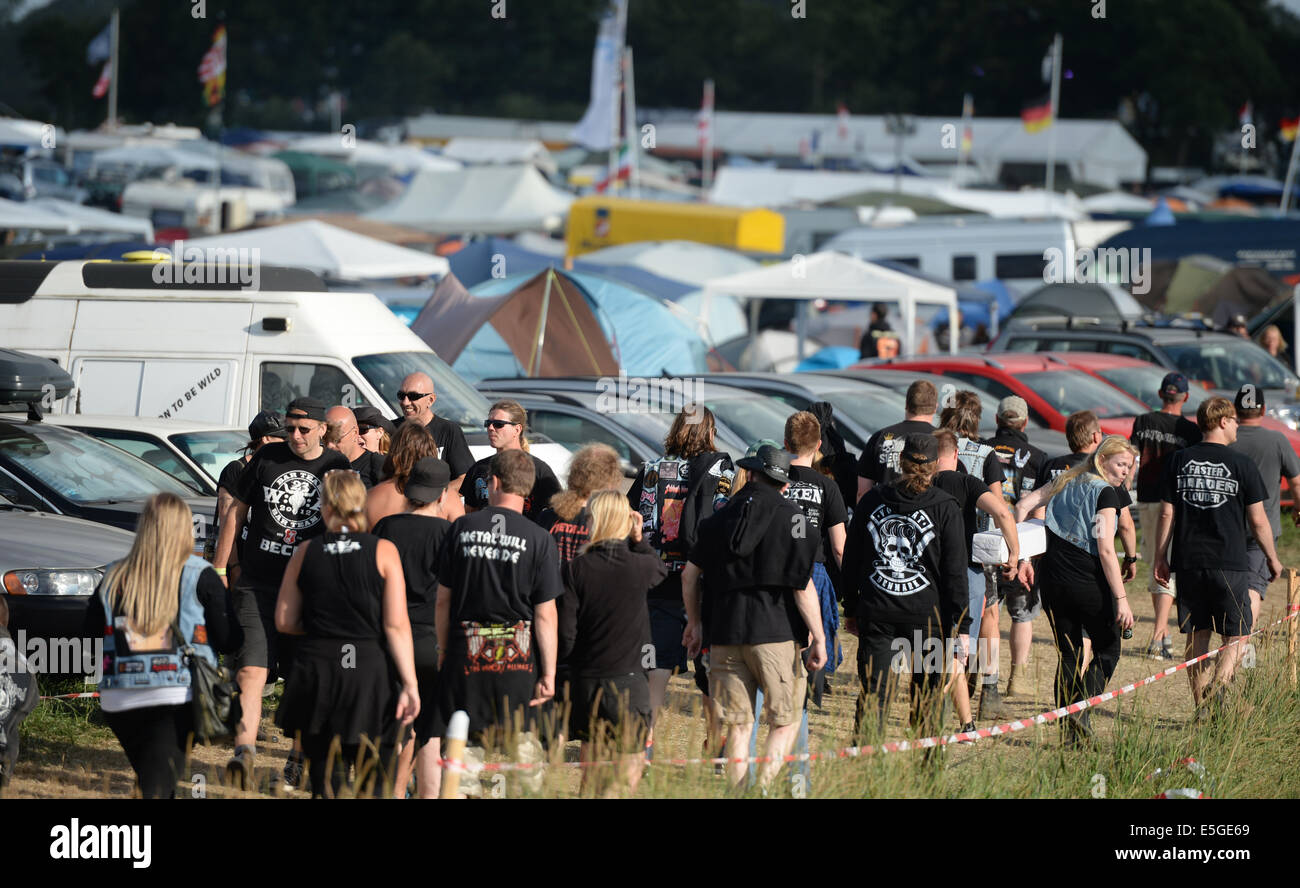 Wacken, Germany. 31st July, 2014. Festival visitors walk across a ...