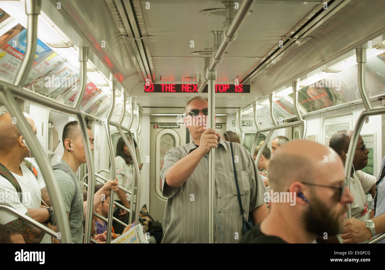 Manhattan, New York, USA. 30th July, 2014. Riders aboard a No. 2 Subway ...