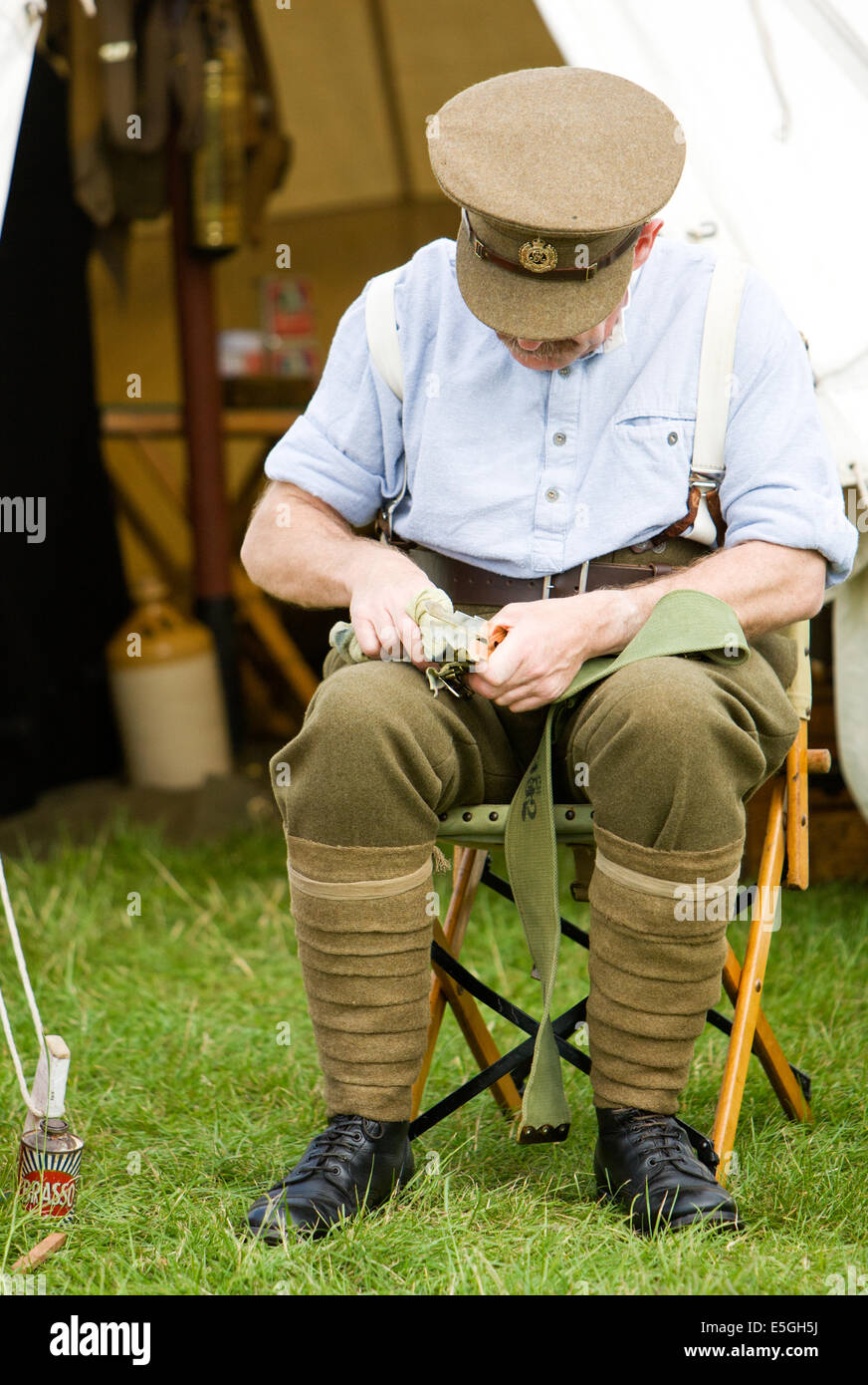 British Army Soldier of the Great War polishing his kit (brasses) with ...