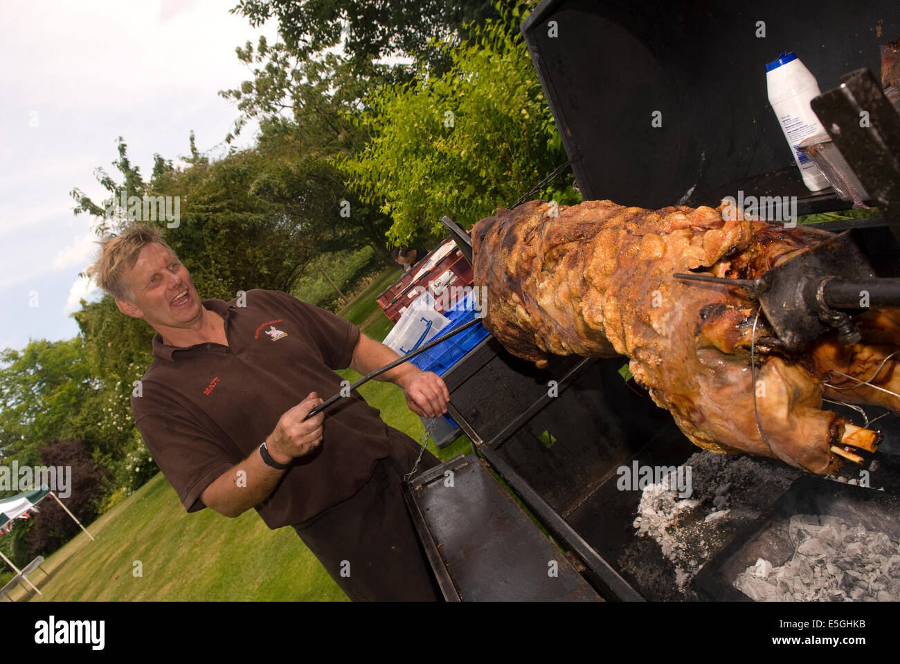 Man cooking Hog Roast for a local community annual picnic, Hampshire ...