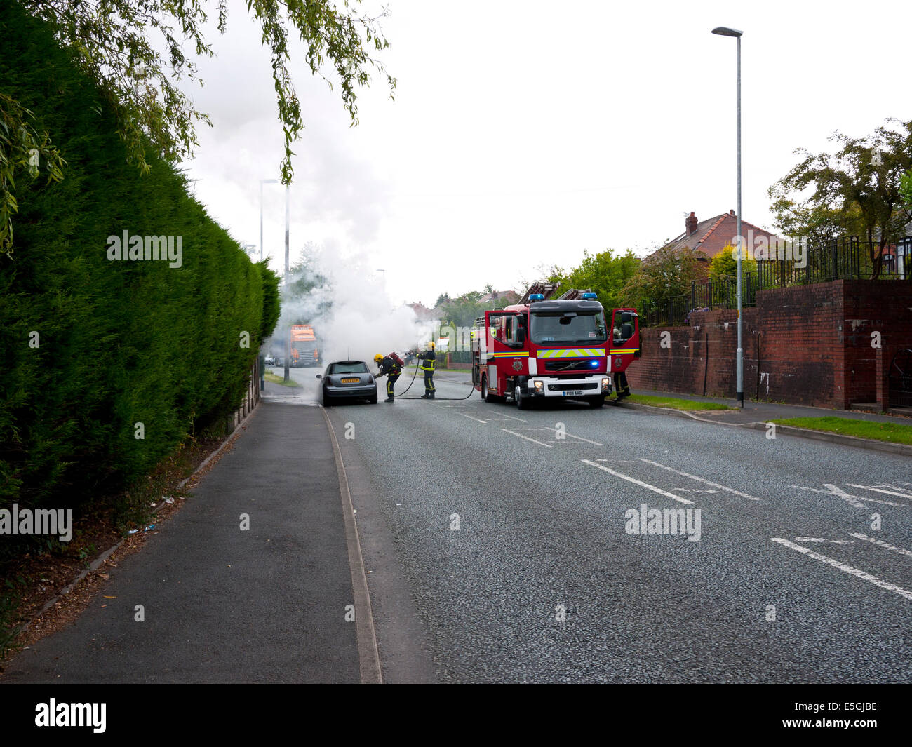 A BMW Mini catches fire and the local fire brigade arrive within ...