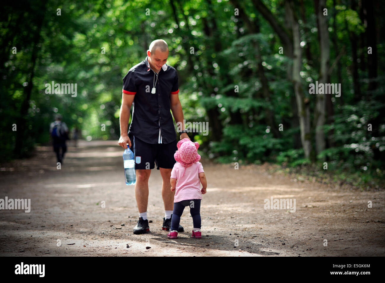 Small girl tries to pass by her father and escape Stock Photo - Alamy