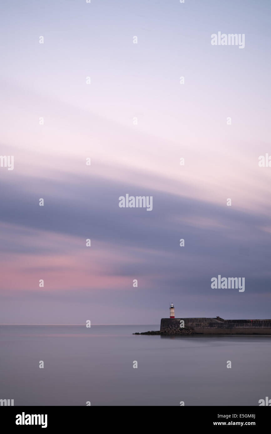 Stunning long exposure landscape lighthouse at sunset with calm sea ...