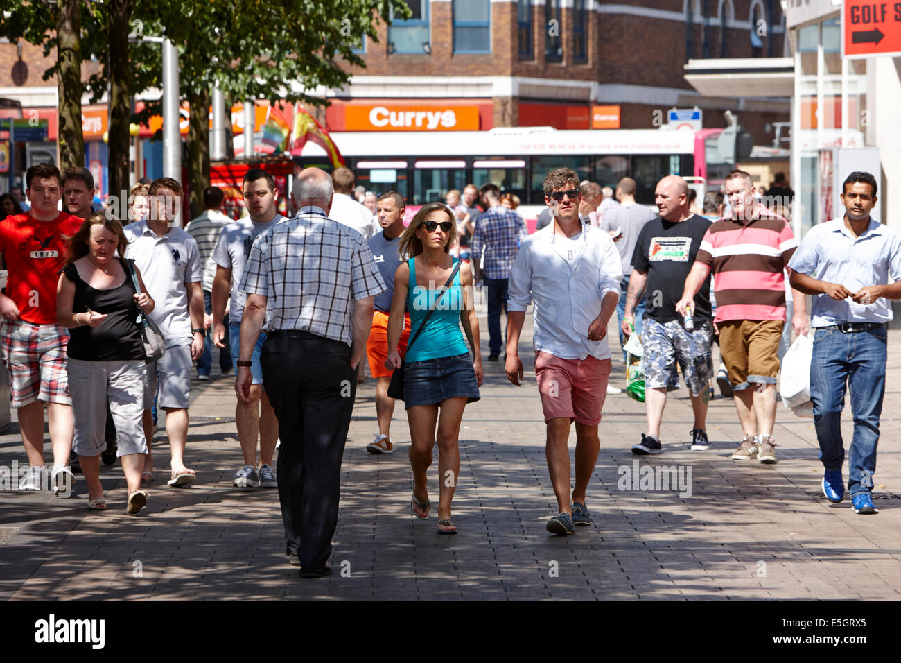 people walking through busy cornmarket on a hot sunny day in Belfast ...