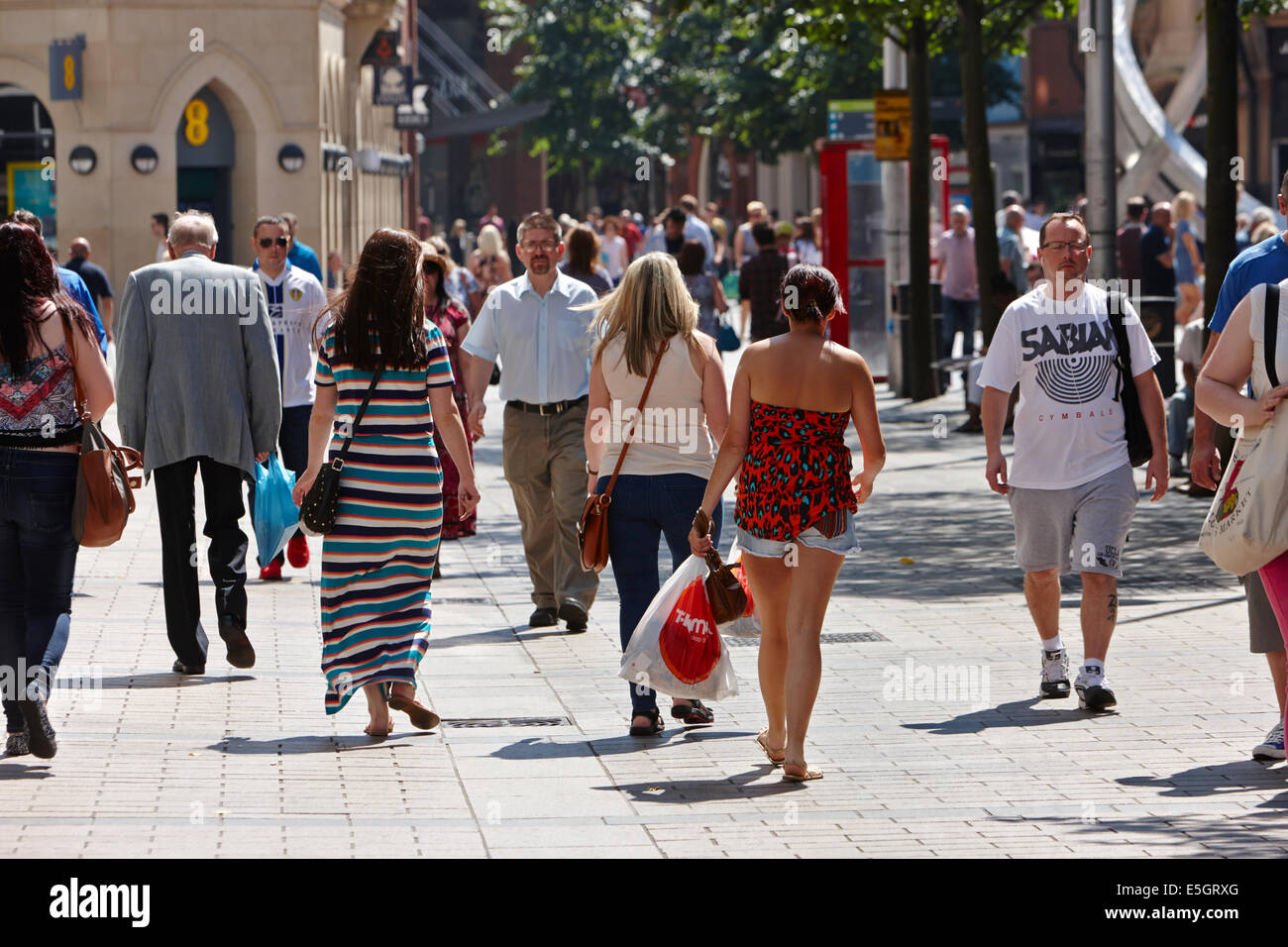 people walking through busy cornmarket on a hot sunny day in Belfast ...