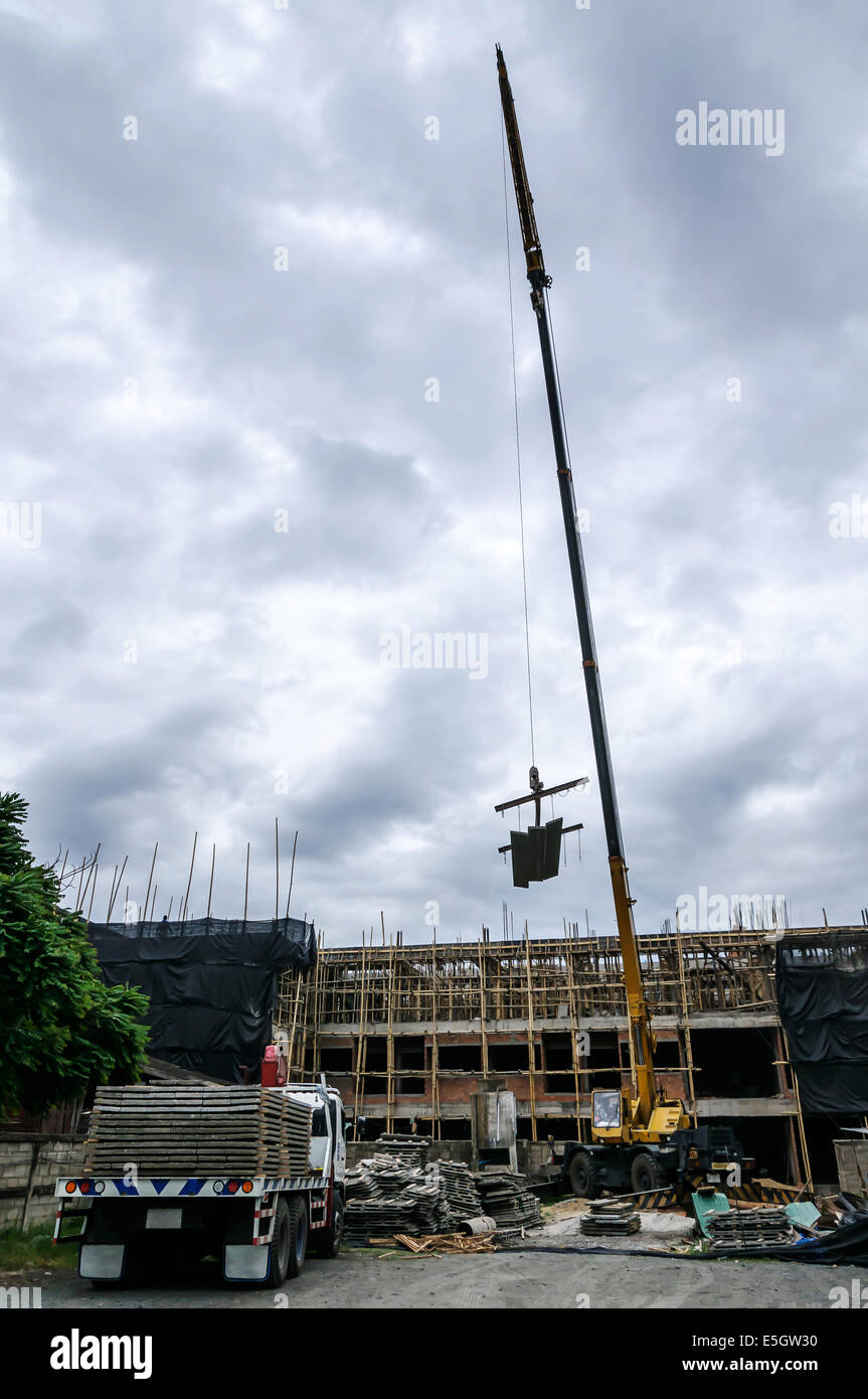 Crane hoist concrete plate at construction site Stock Photo - Alamy